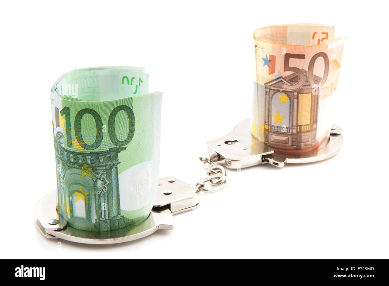 Money in handcuffs on a white background Stock Photo - Alamy