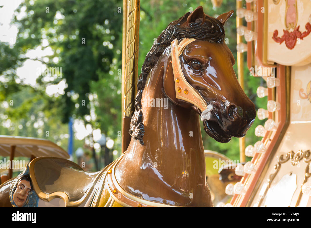 a brown horse of a carousel in a park Stock Photo - Alamy