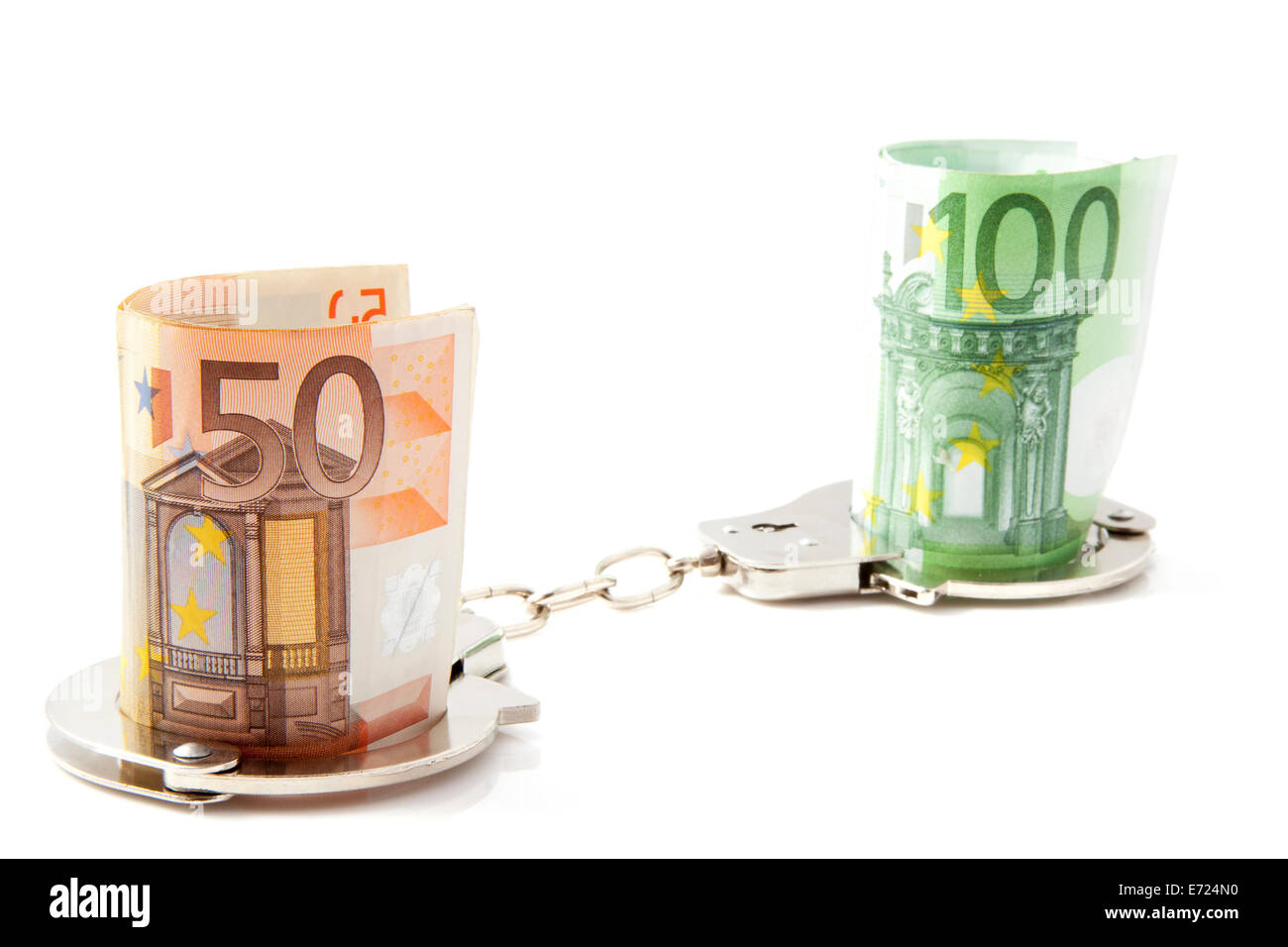 Money in handcuffs on a white background Stock Photo - Alamy