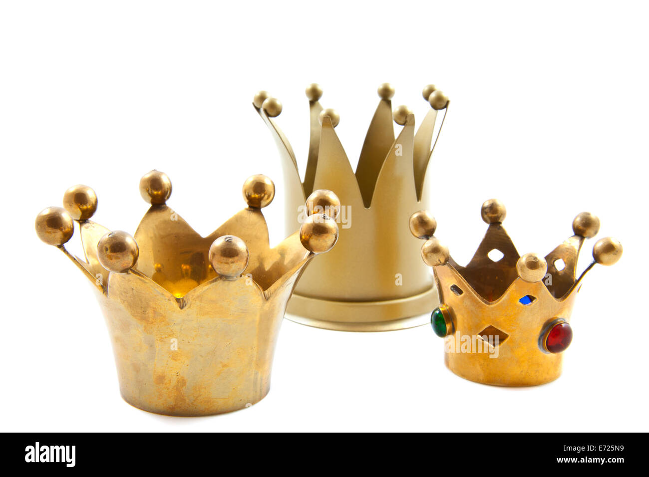 Three golden crowns on a white background Stock Photo - Alamy