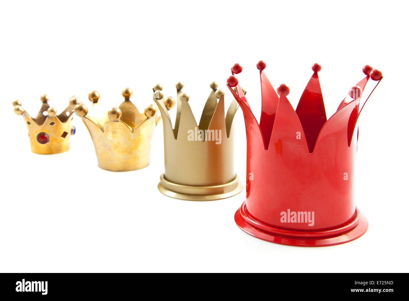 Four crowns in a row on a white background Stock Photo - Alamy