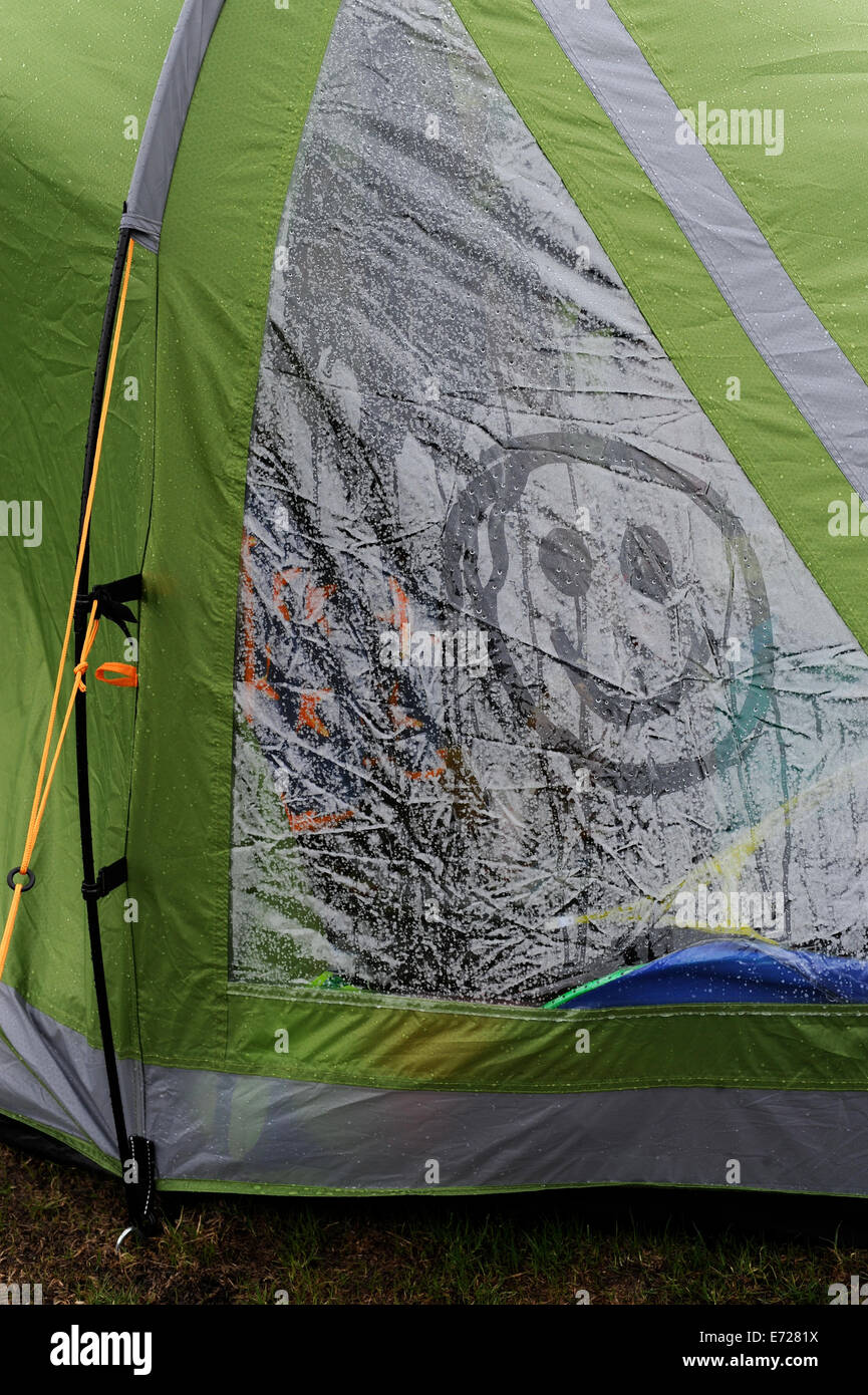 hand drawn smiley face drawn into condensation on a tent while camping ...