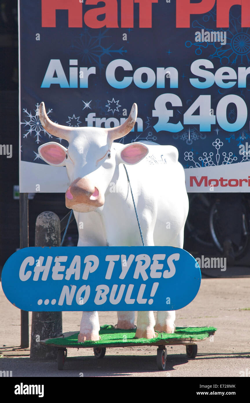 Large white plastic bull on garage forecourt Stock Photo - Alamy