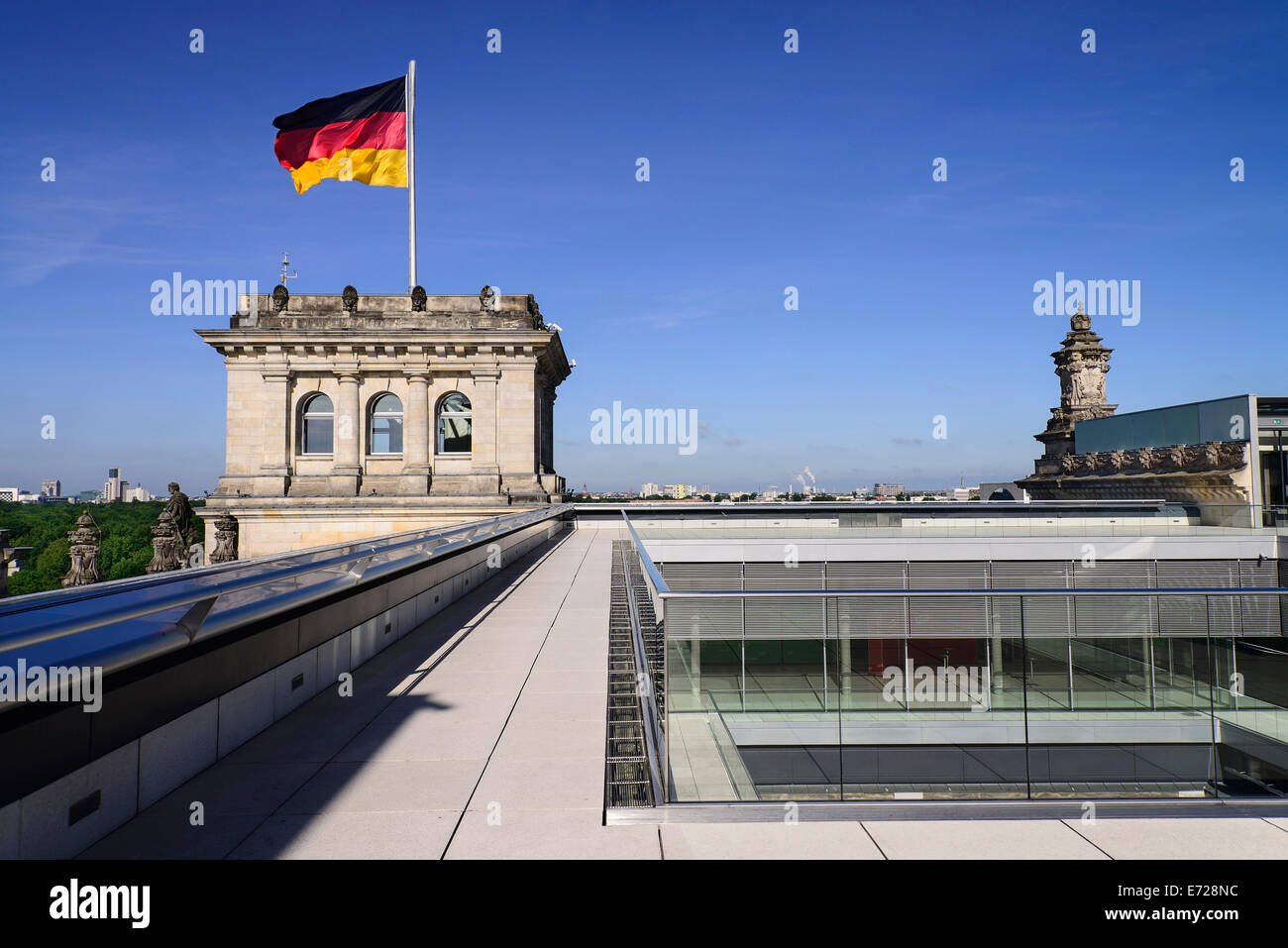 Germany, Berlin, German flag fluttering on a corner tower of the ...