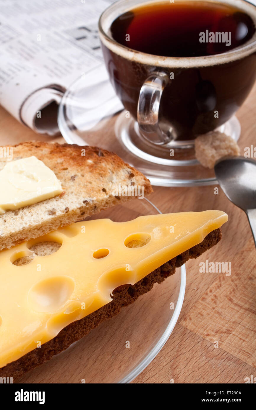 breakfast with coffee, cheese and butter on toast and a newspaper Stock ...