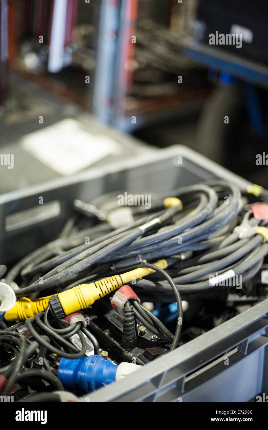 bunches of cables placed in a grey plastic box in an indutrial setting ...
