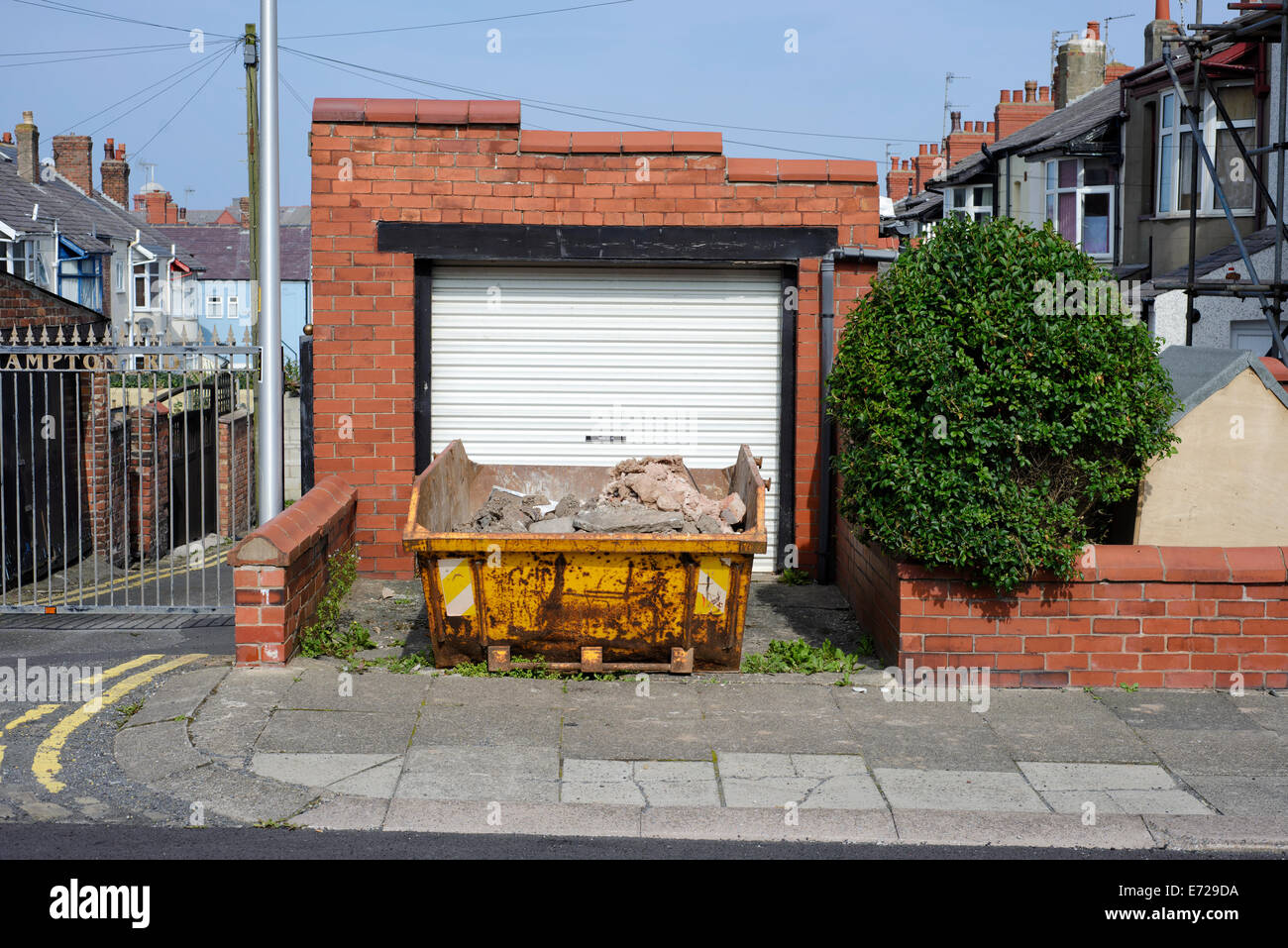 Skip containing builders rubble outside a garage in Blackpool ...