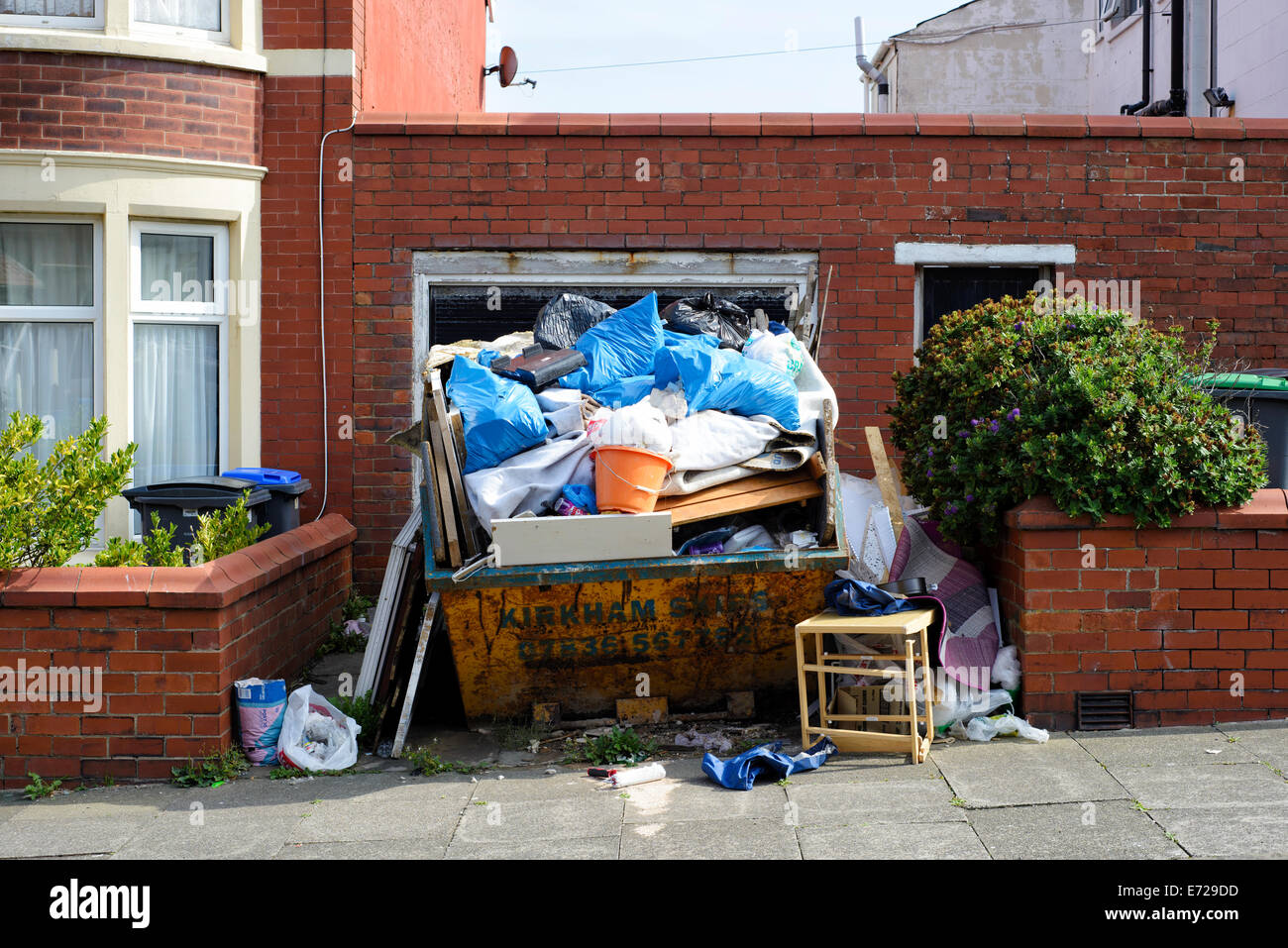Overloaded skip outside a house in Blackpool, Lancashire Stock Photo ...