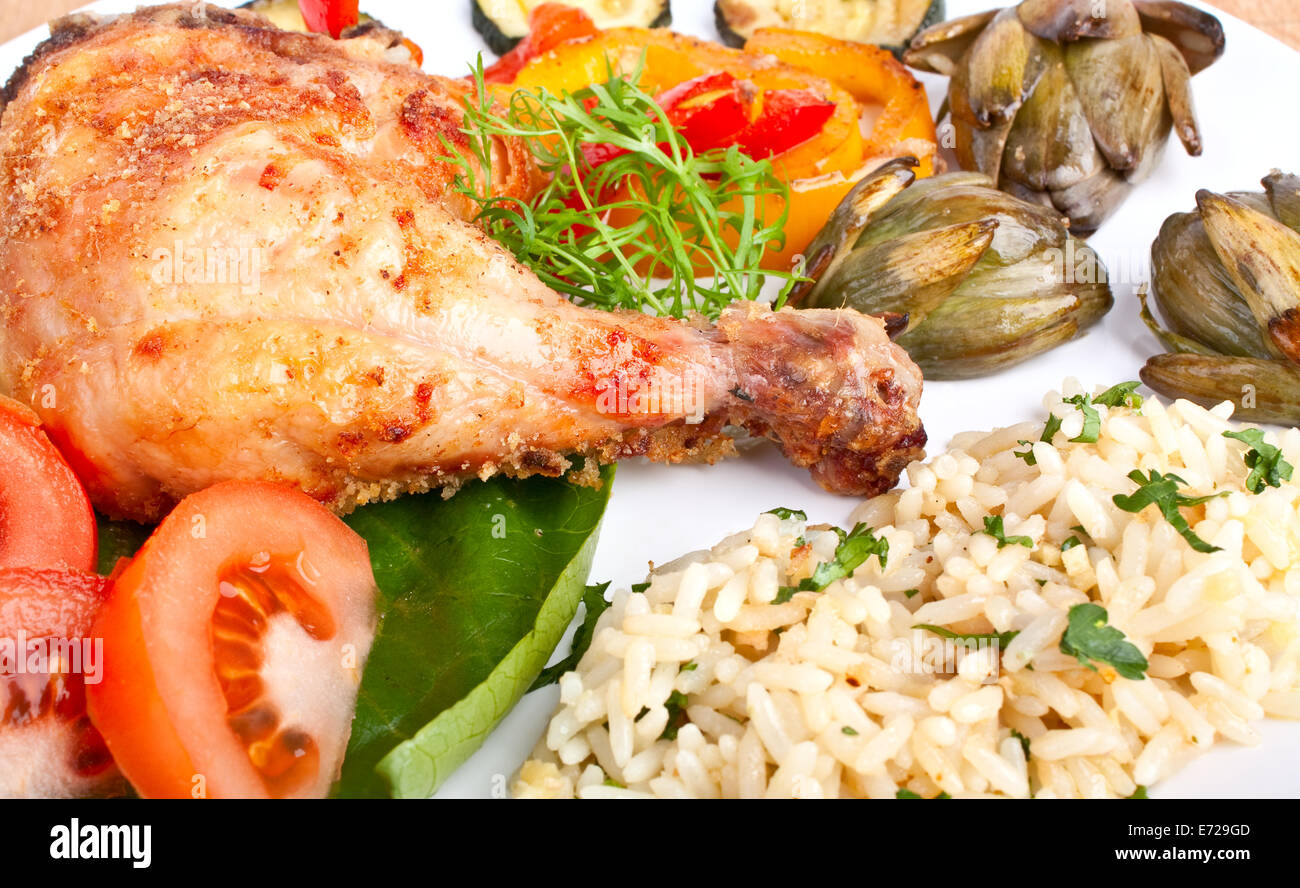 roasted chicken leg with rice and vegetables Stock Photo - Alamy