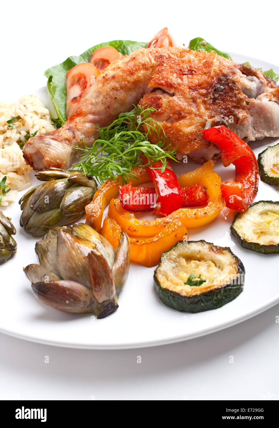 roasted chicken leg with rice and vegetables Stock Photo - Alamy