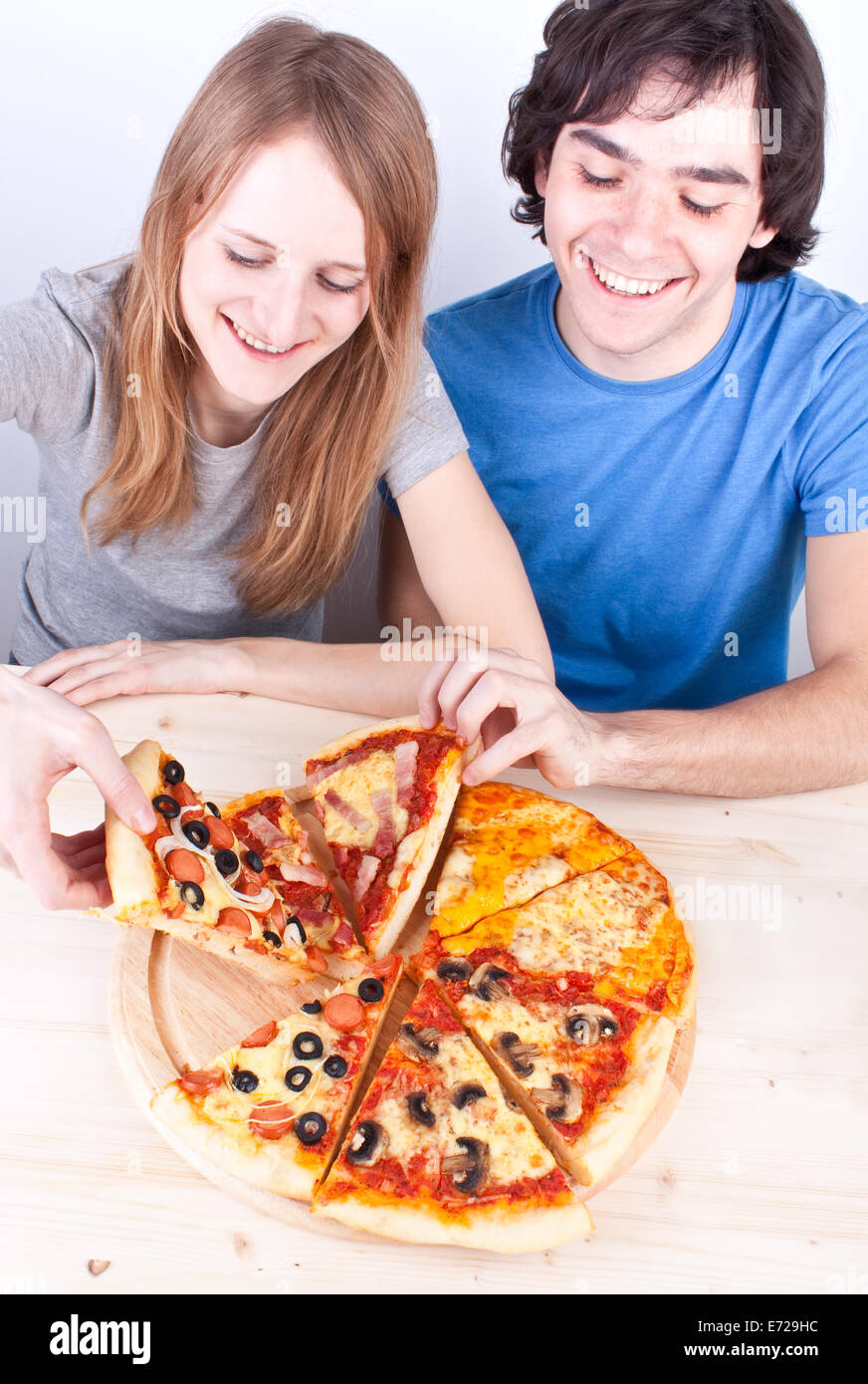 Two People Eating Pizza