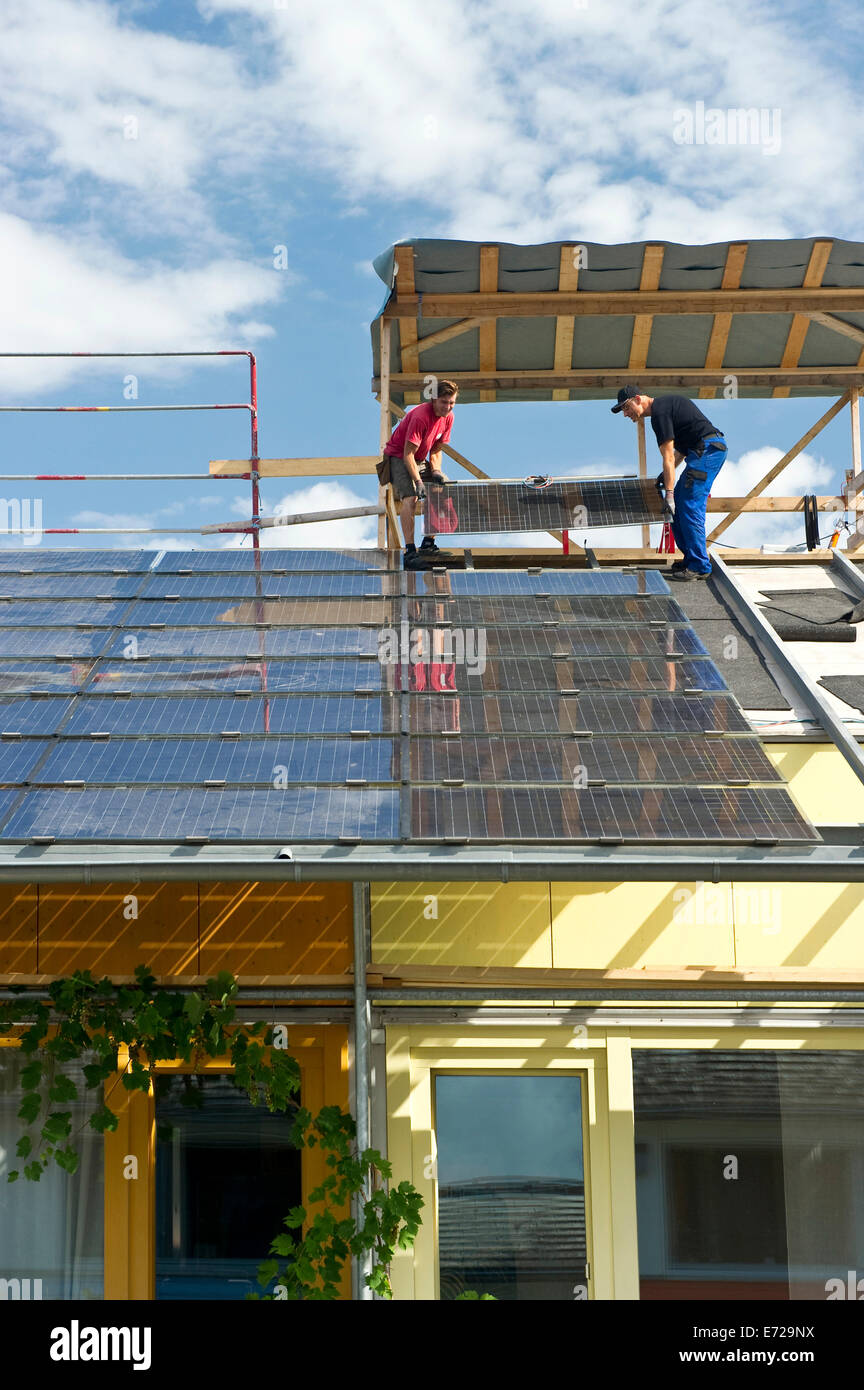 Solar panels being installed on a roof, solar village in the Vauban ...