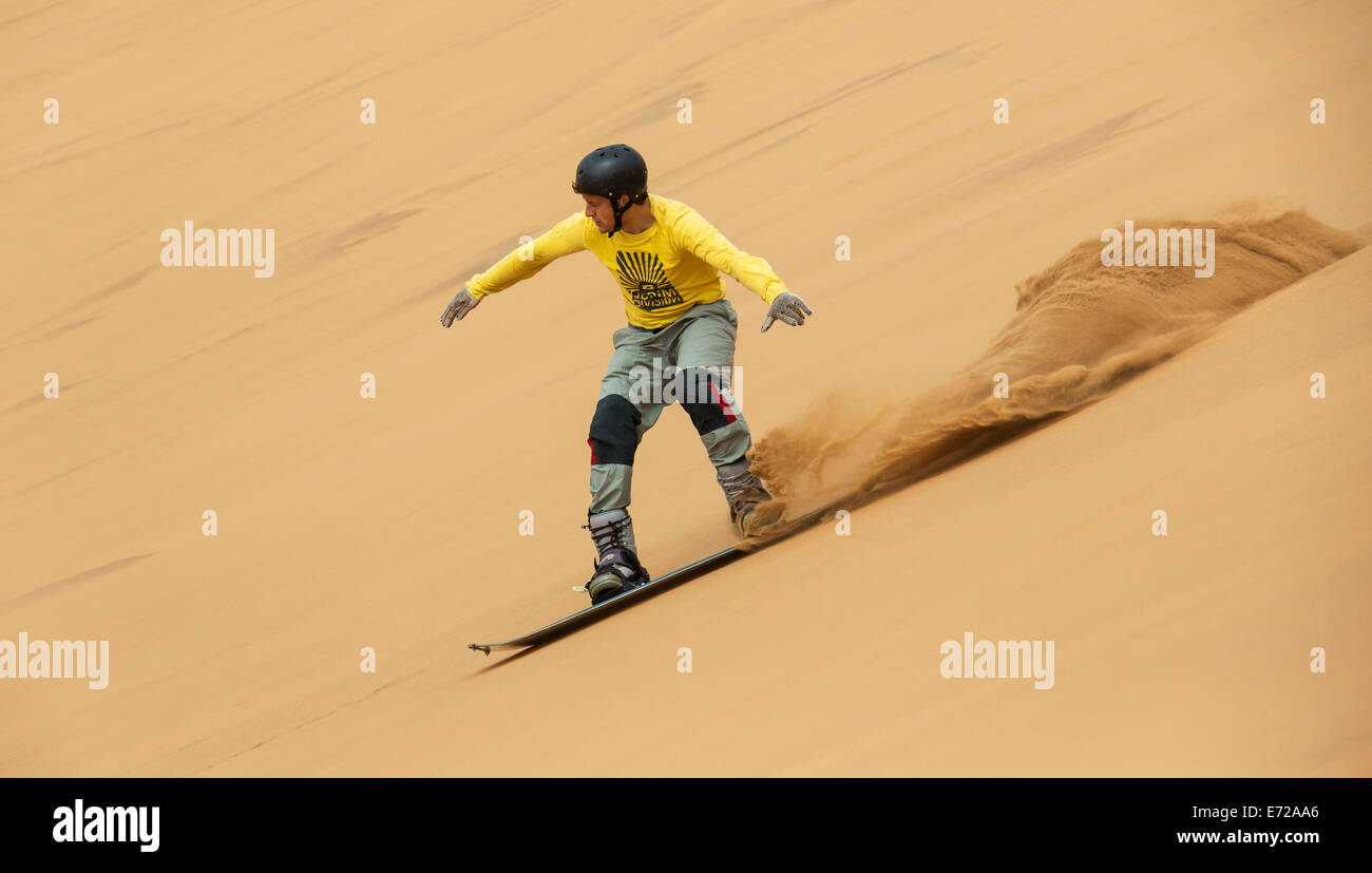 Sand boarding in the dunes of the Namib Desert, near Swakopmund, Namibia Stock Photo - Alamy
