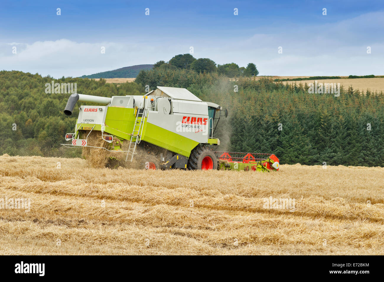 COMBINE HARVESTER ABERDEENSHIRE SCOTLAND WITH STRAW POURING FROM THE ...