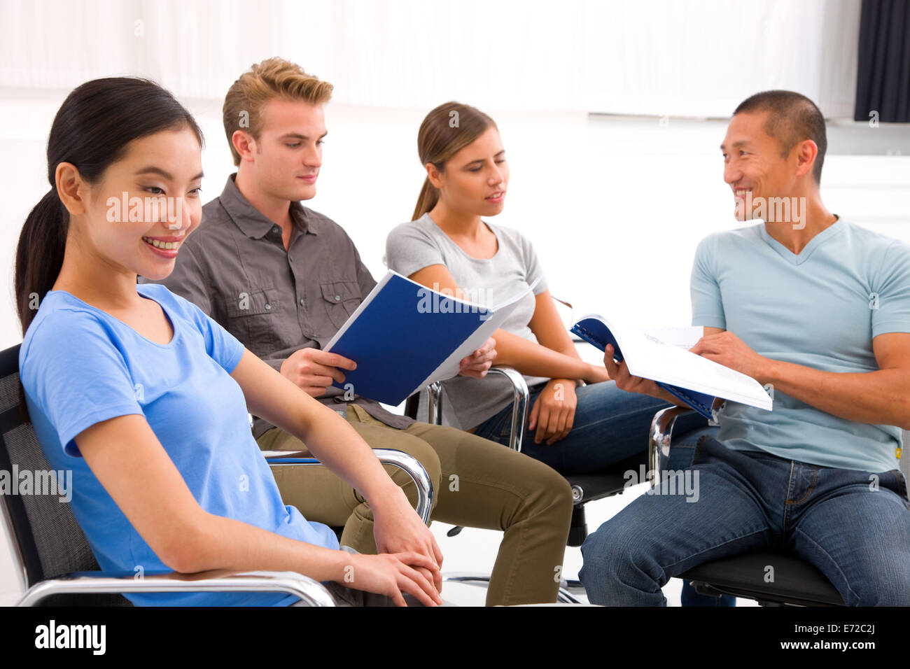 Business partners discussing papers meeting Stock Photo - Alamy