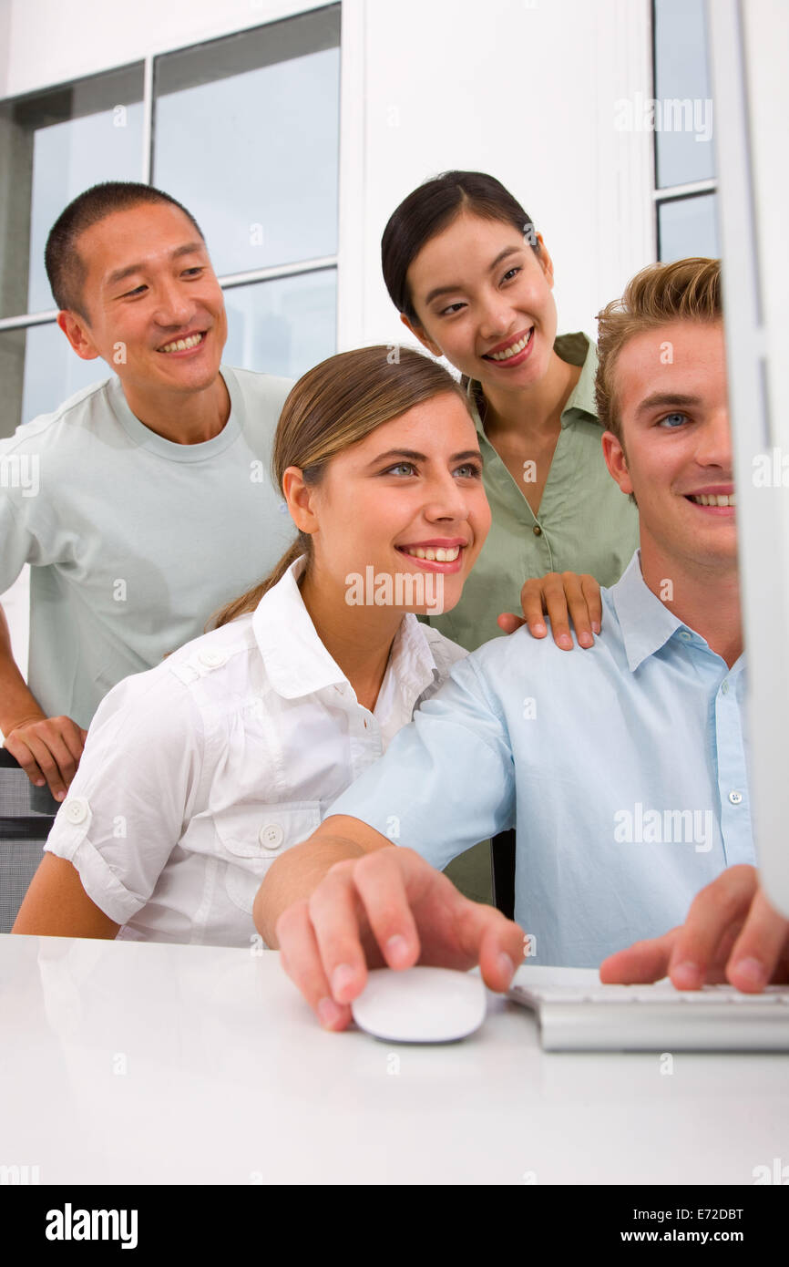 Multi ethnic group of people looking computer Stock Photo - Alamy