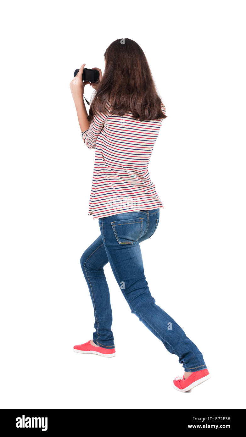 Back view of woman photographing. girl photographer in jeans. Rear view ...