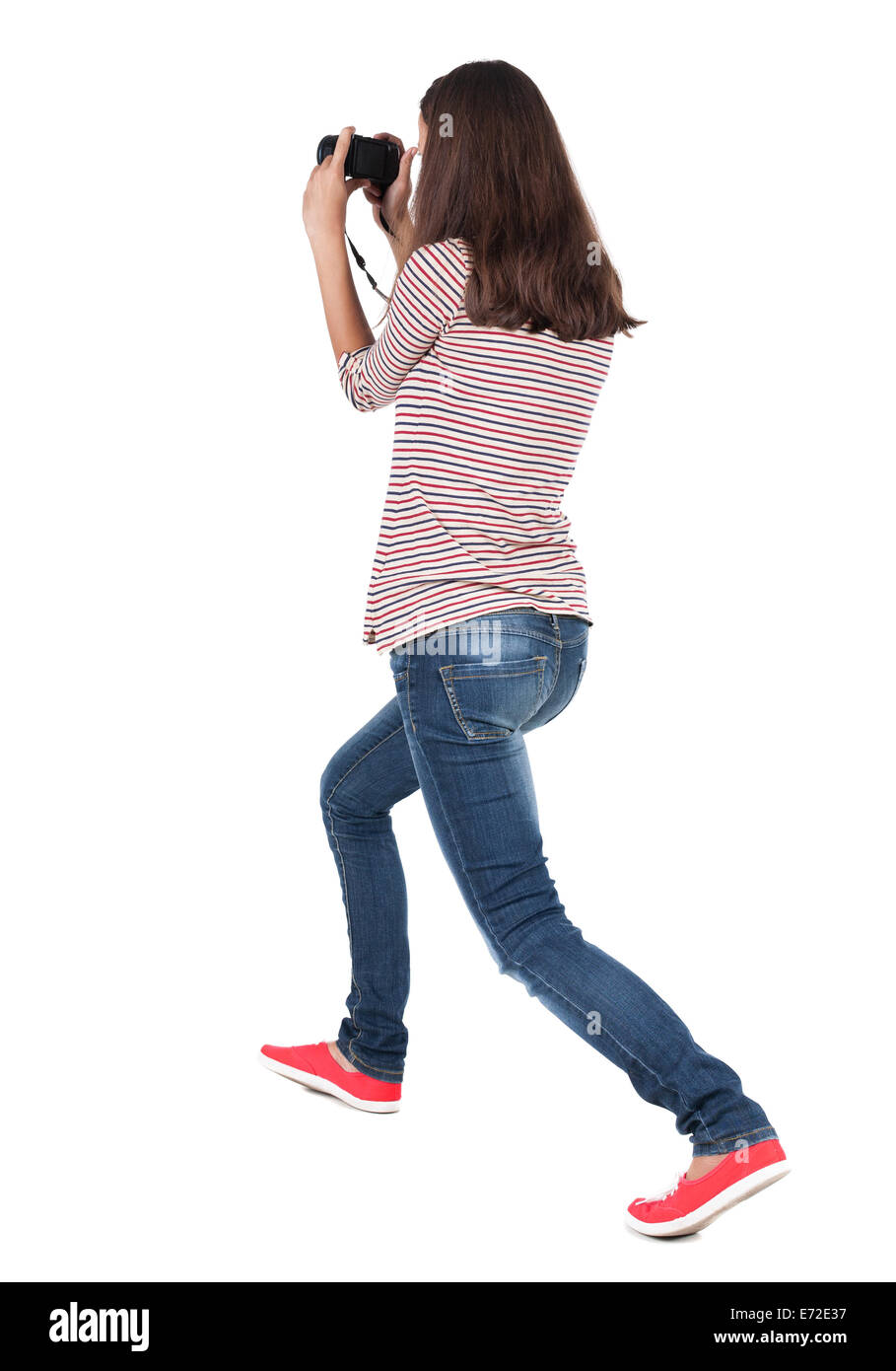 Back view of woman photographing. girl photographer in jeans. Rear view ...