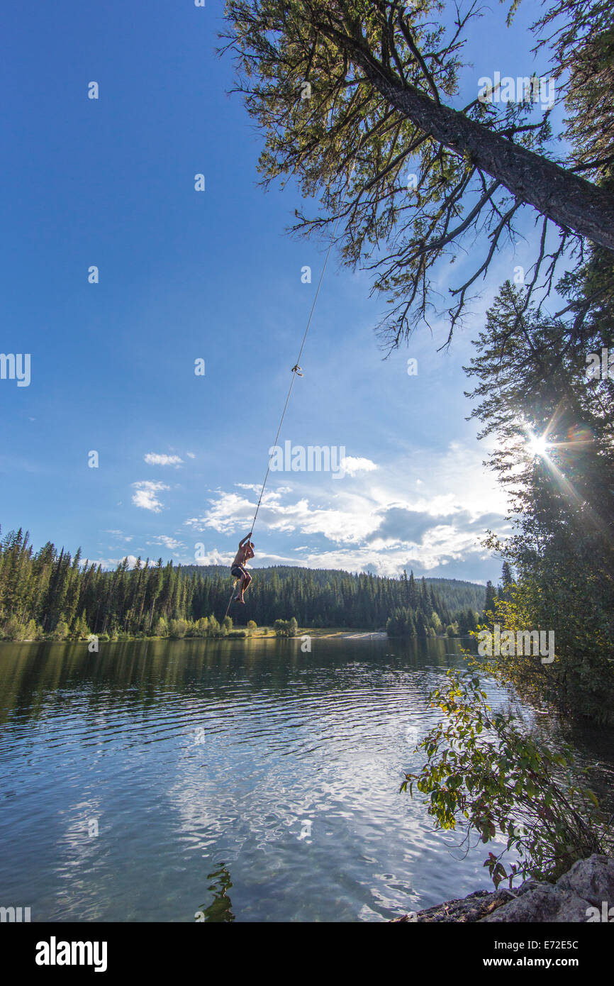Jumping off a tree rope on a summer day at Champion Lakes Provincial ...