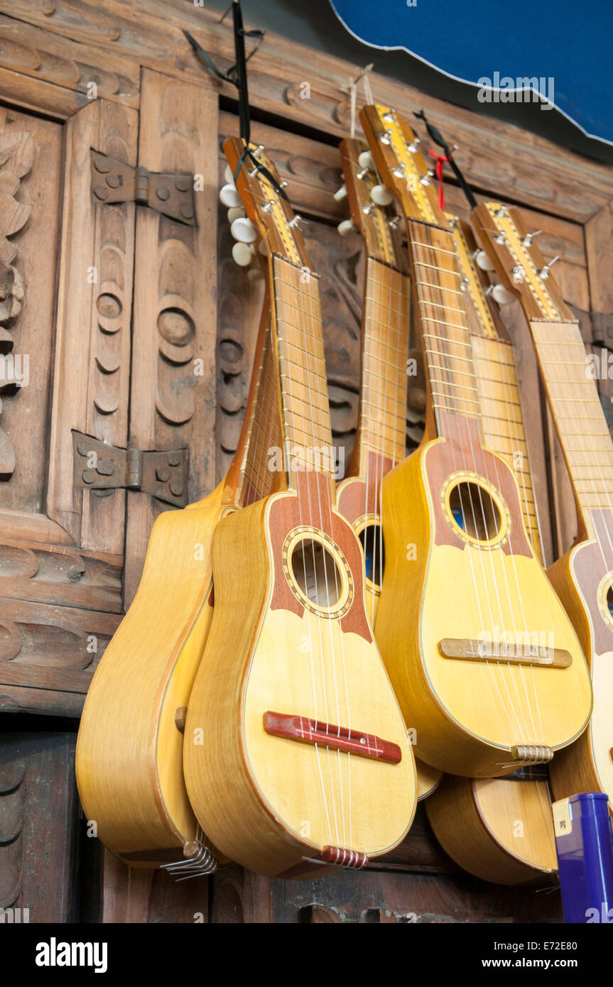 small yellow colored guitars to play music Stock Photo - Alamy