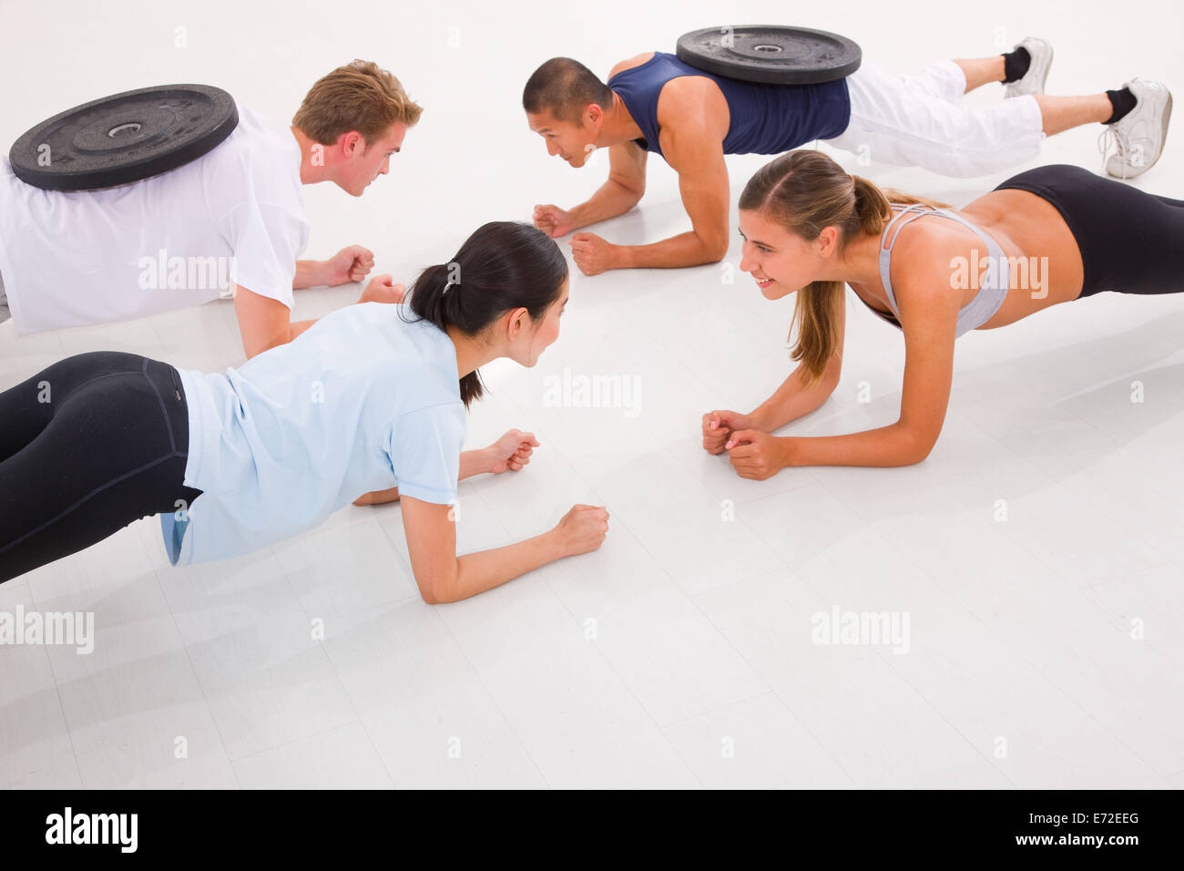 Young multi ethnic people exercising in gym Stock Photo - Alamy