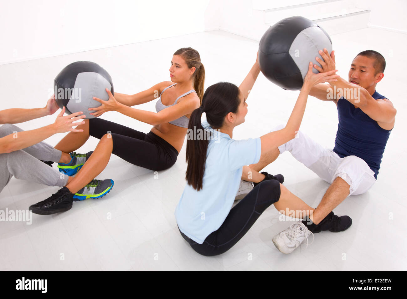 Diverse group of people exercising with pilates in gym Stock Photo - Alamy