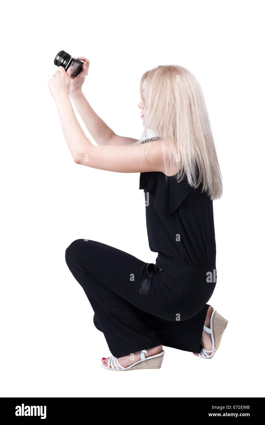 Back view of woman photographing. girl photographer in jeans. Rear view ...