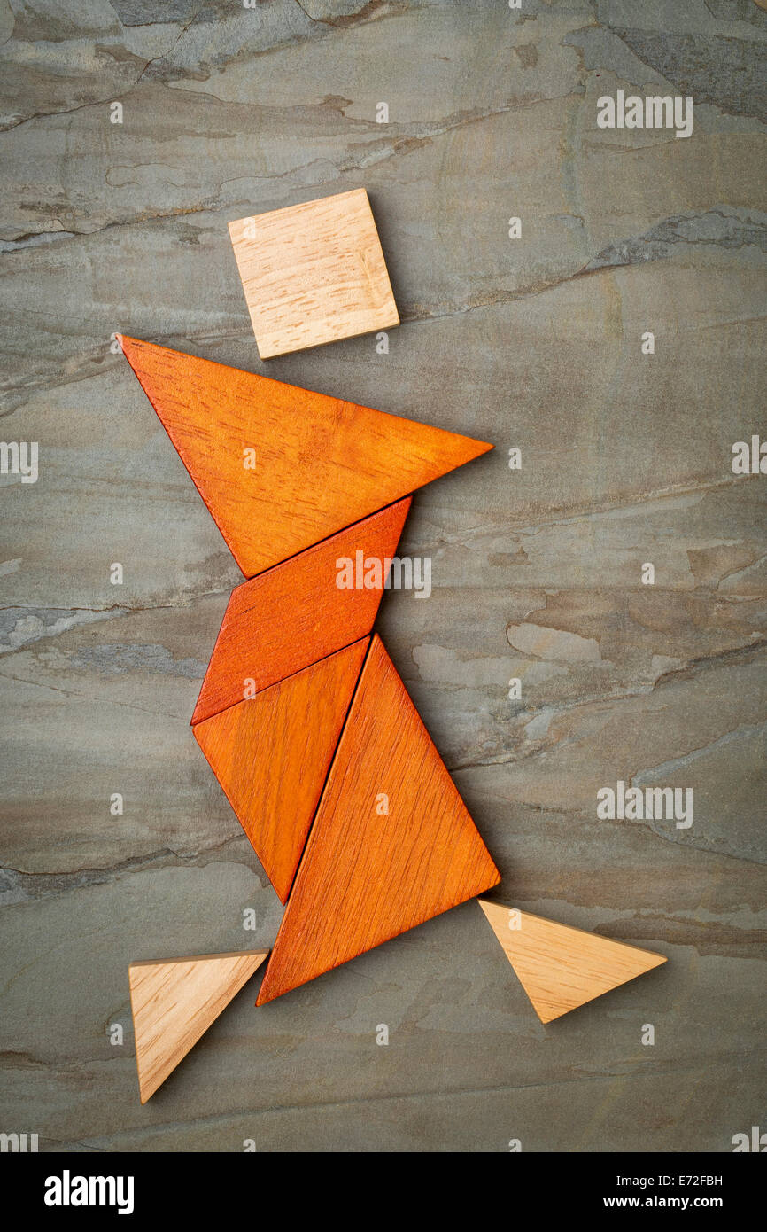 abstract figure of a female dancer built from seven tangram wooden ...