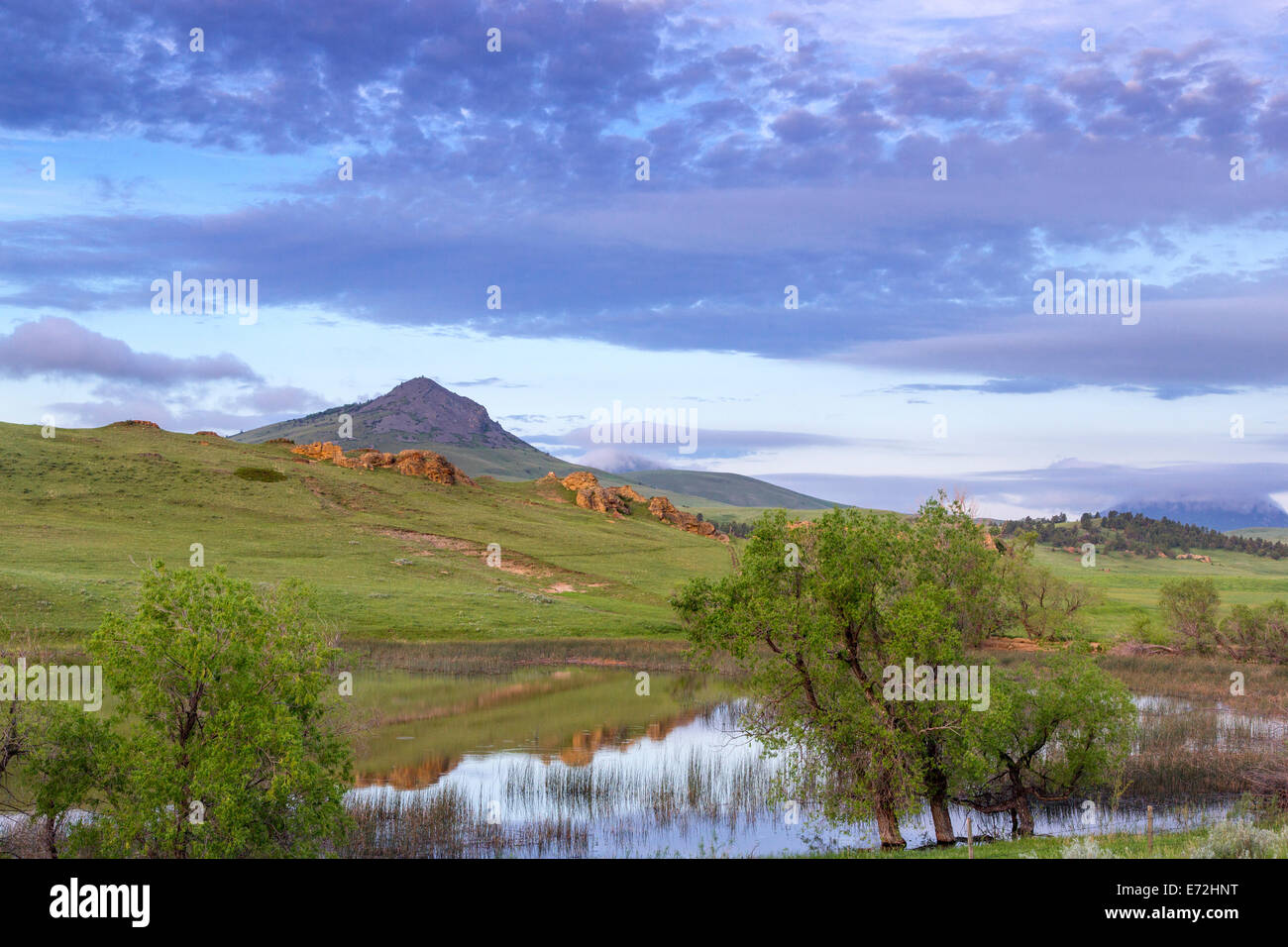 Small ranch pond reflects morning clouds and outcroppings in the Bears ...