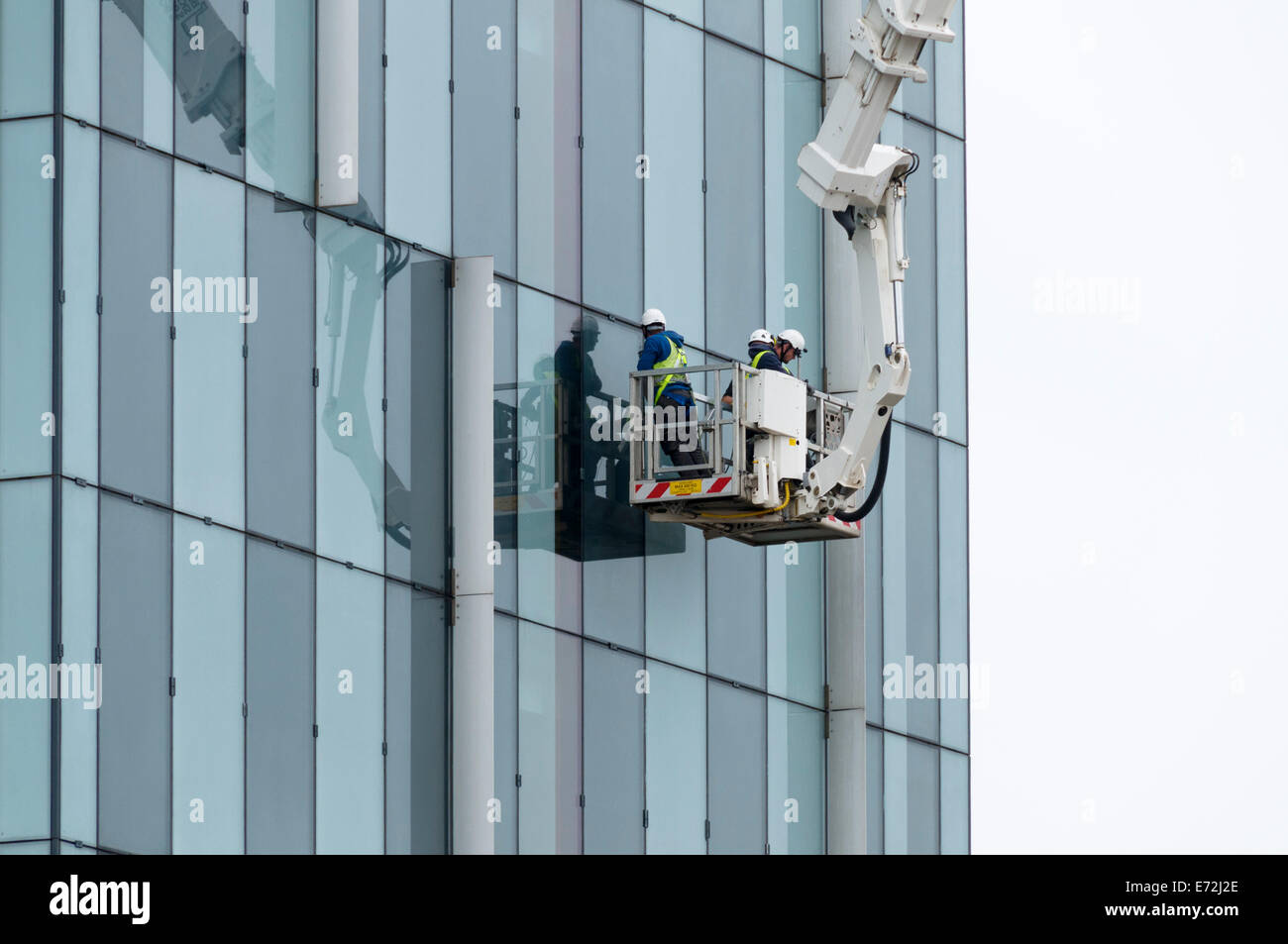 Maintenance workers in an access platform cradle at the Beetham Tower ...