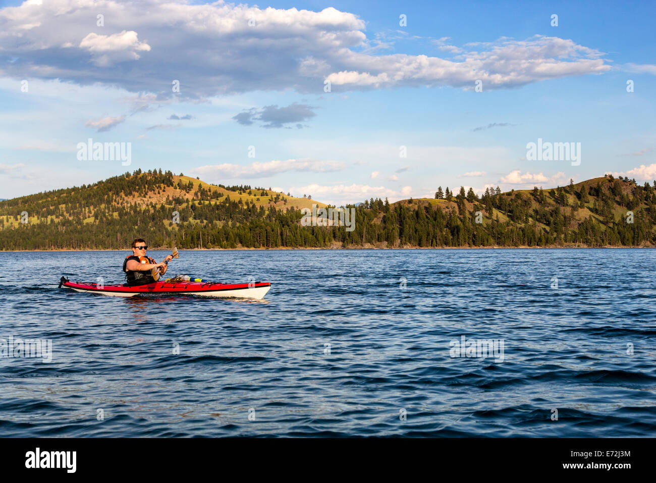 Logan Haney sea kayaking on Flathead Lake with Wild Horse Island State ...
