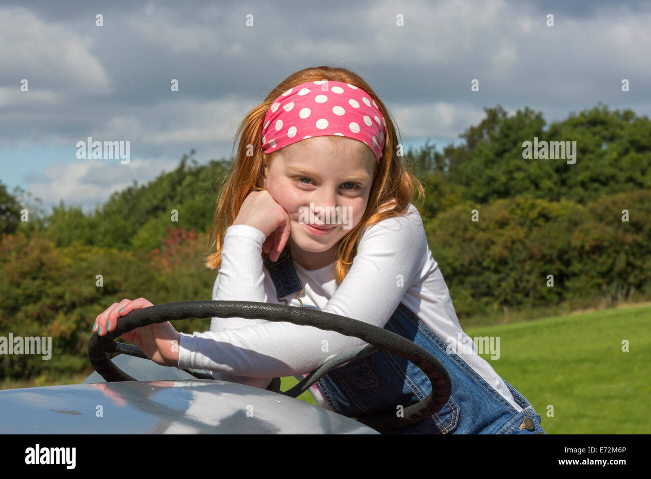 Morag Brown, aged 8 years sitting on a tractor while at a display of ...