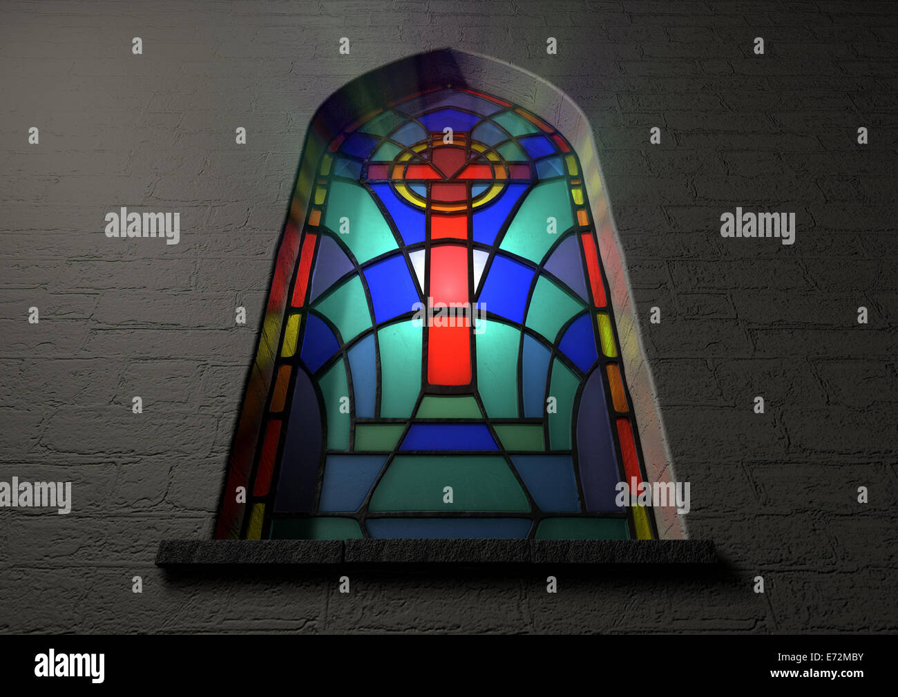 A colorful patterned stain glass window with the shape of a crucifix ...