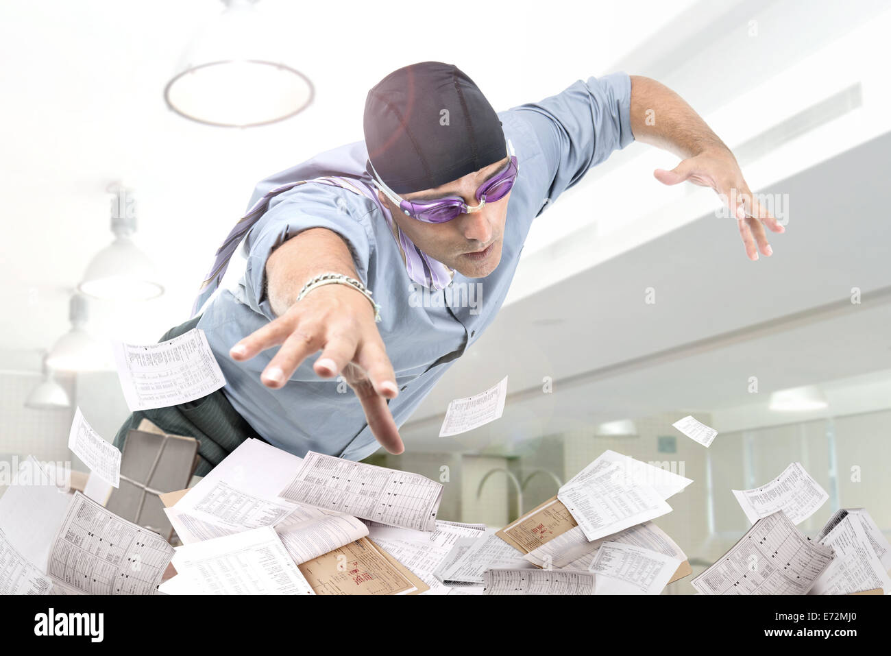 Businessman swimming in a pool of papers Stock Photo - Alamy