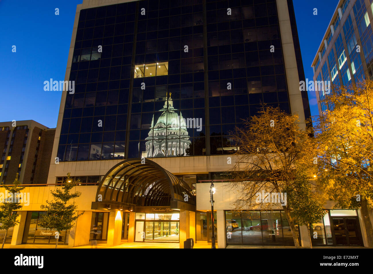 State capitol building reflects into office building in Madison ...
