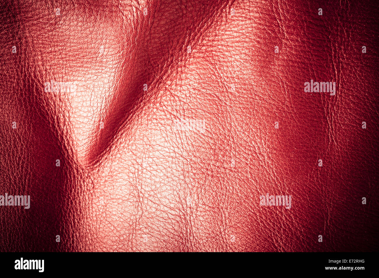 Red leather texture background closeup. Folds wavy natural skin ...