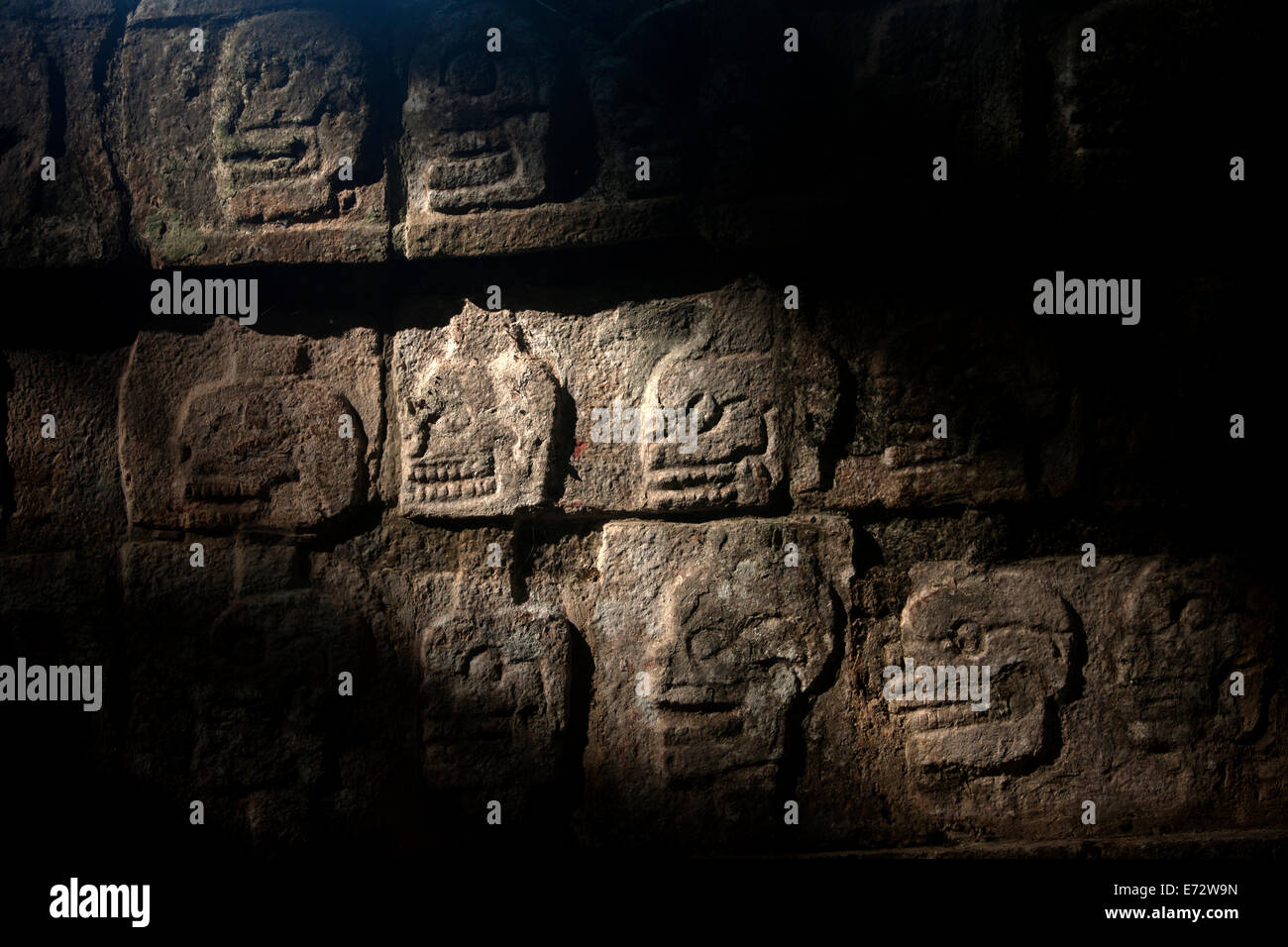 Skulls decorate the tzompantli or Skull Platform in the Mayan city of ...