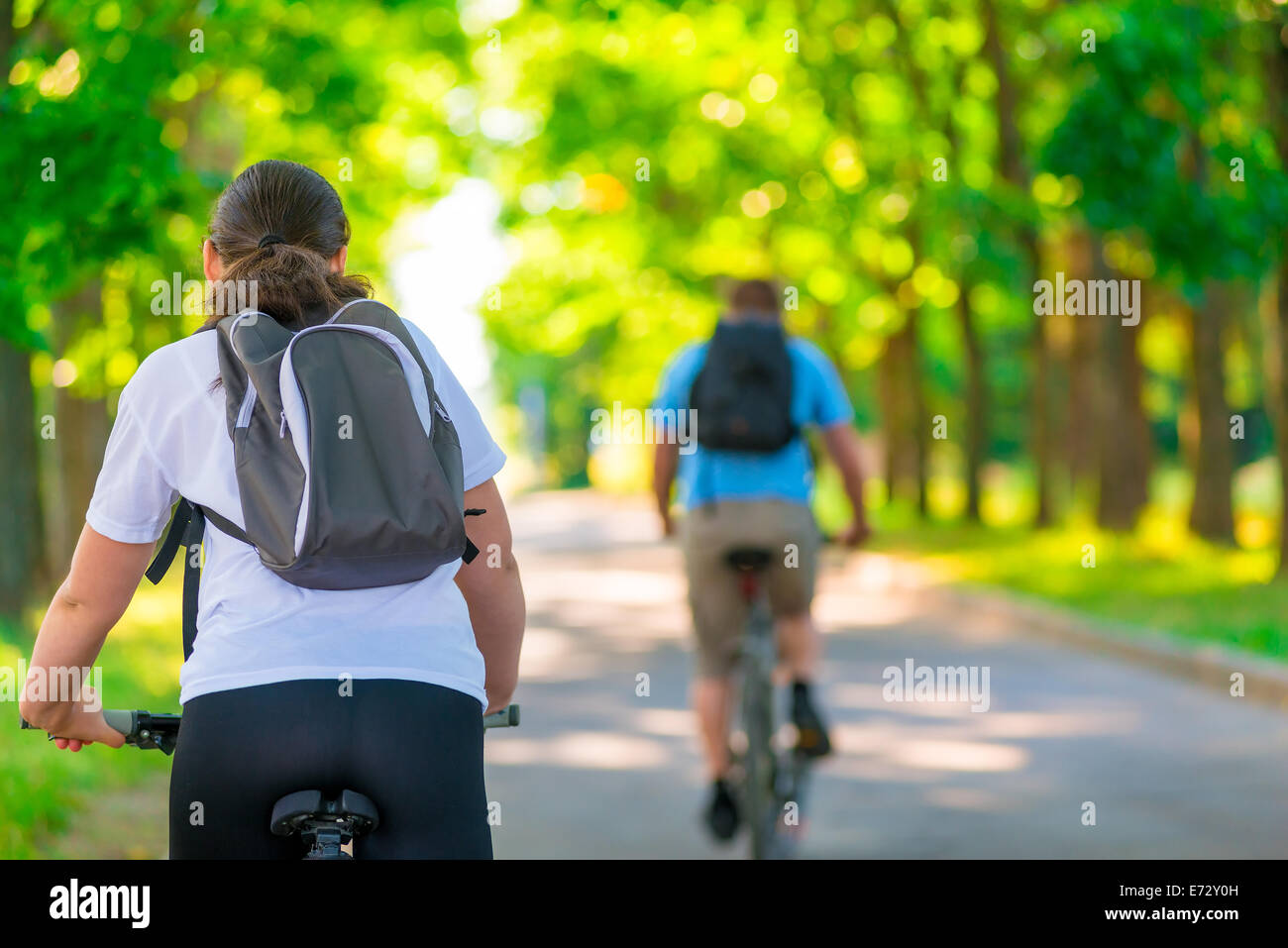 people ride bicycles in summer park Stock Photo - Alamy