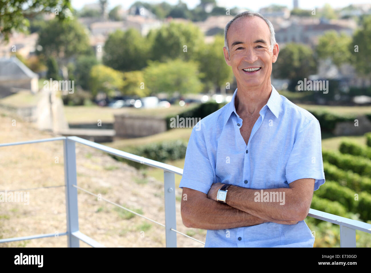 Man leaning against railing Stock Photo - Alamy