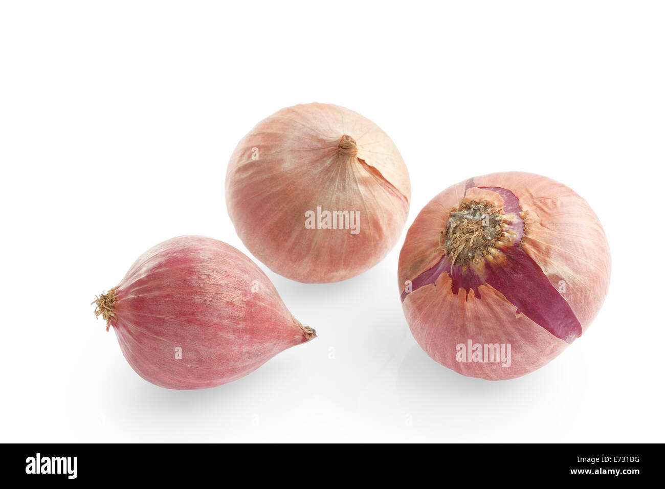 group of small red shallot on white background Stock Photo - Alamy