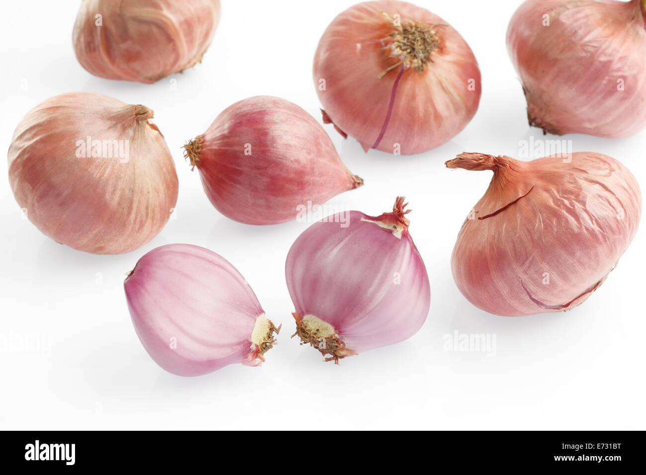 group of small red shallot on white background Stock Photo - Alamy