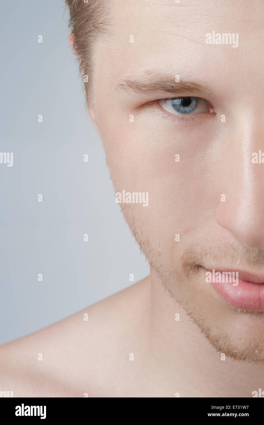 portrait of young man smiling, half face Stock Photo - Alamy