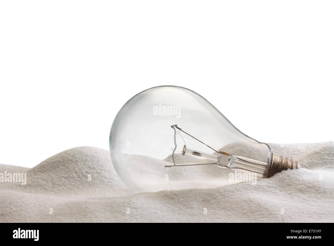 electric lamp bulb on sand and white background Stock Photo - Alamy