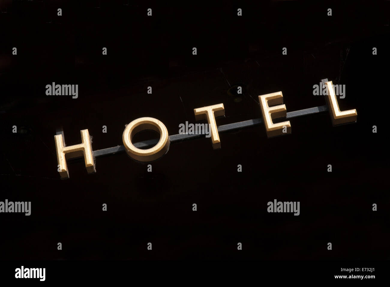 Gold Hotel Sign on Black Background Stock Photo - Alamy