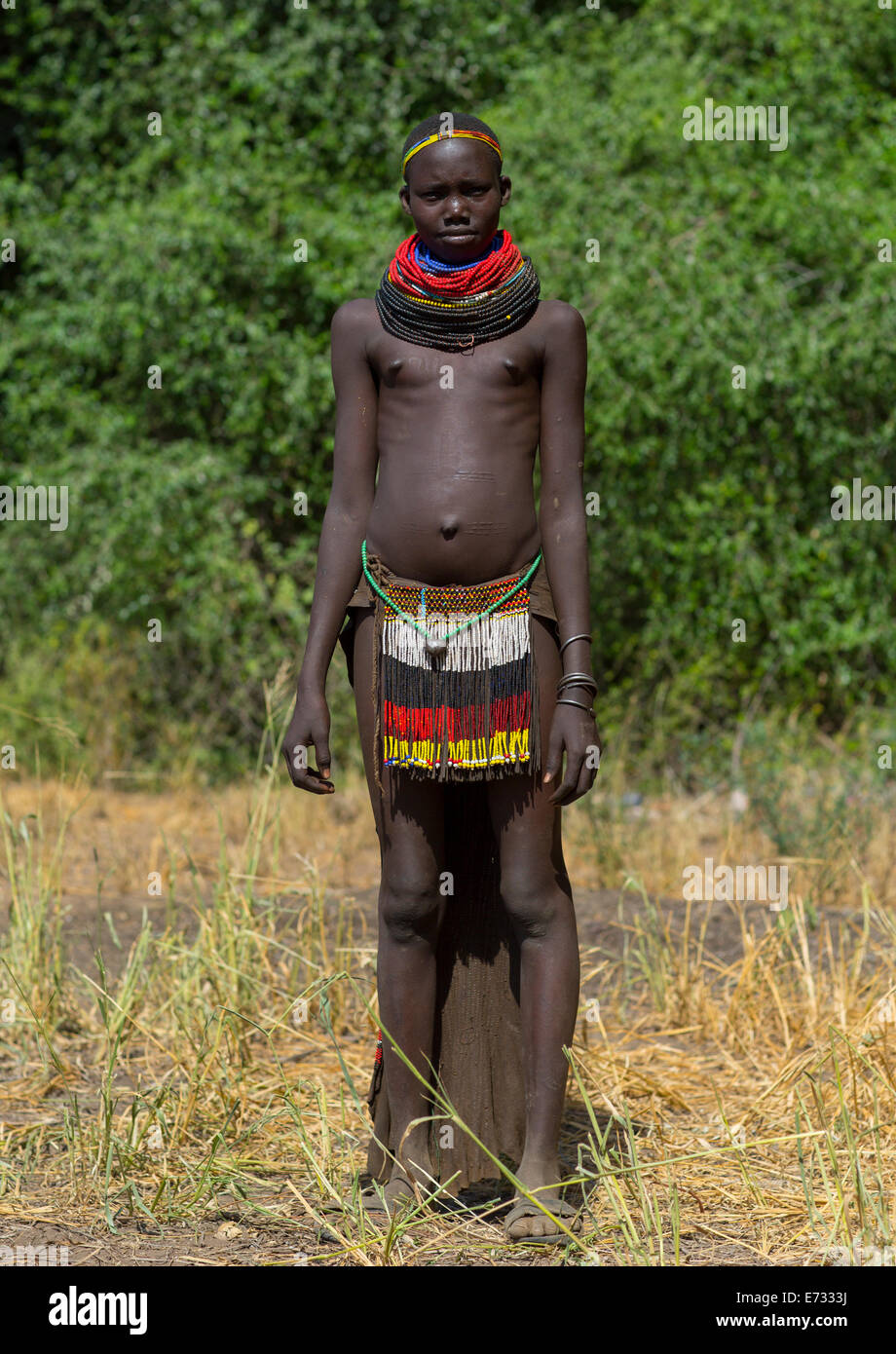 Portrait Of A Nyangatom Tribe Girl With Traditional Beaded Skirt, Omo ...