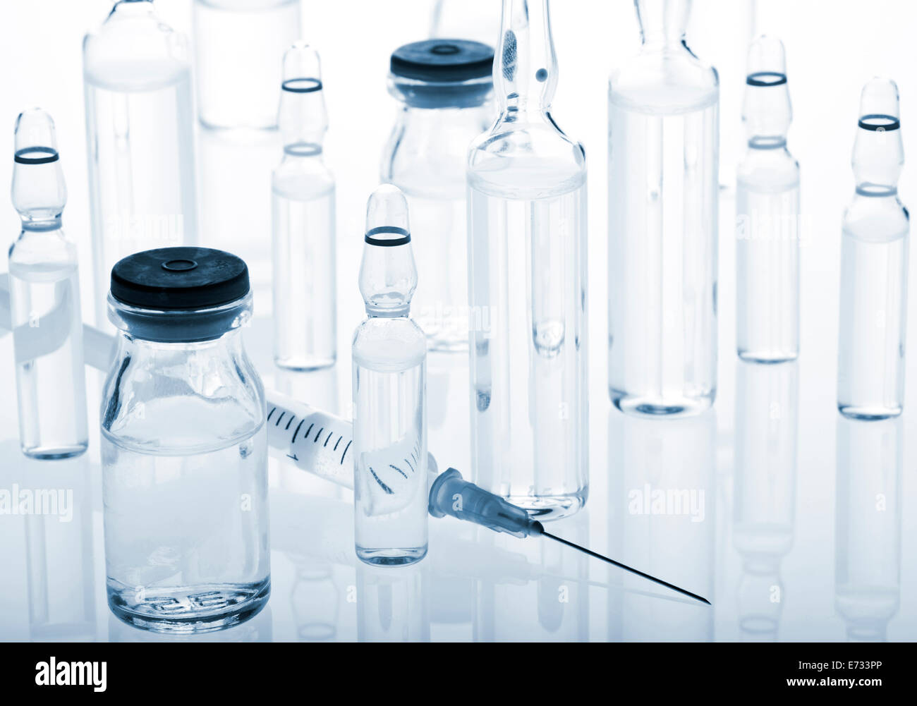 Glass Medicine Vials with liquid, ampoules and syringe Stock Photo - Alamy