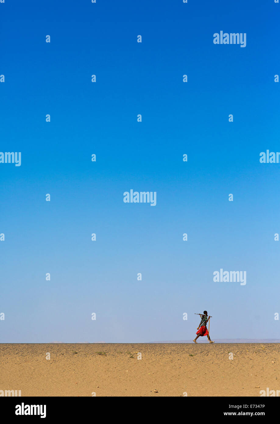 Afar Tribe Man Walking Alone In The Desert, Assayta, Ethiopia Stock ...
