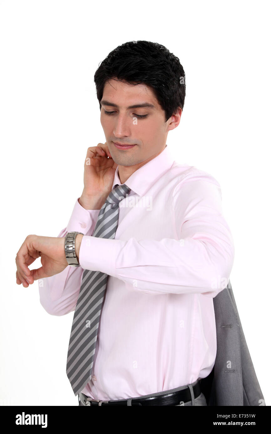 A businessman checking his watch Stock Photo - Alamy