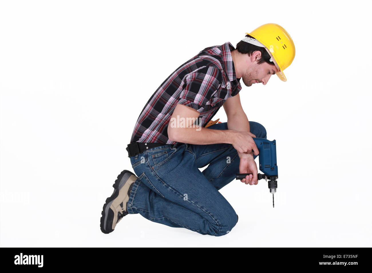 Tradesman using a power tool Stock Photo - Alamy