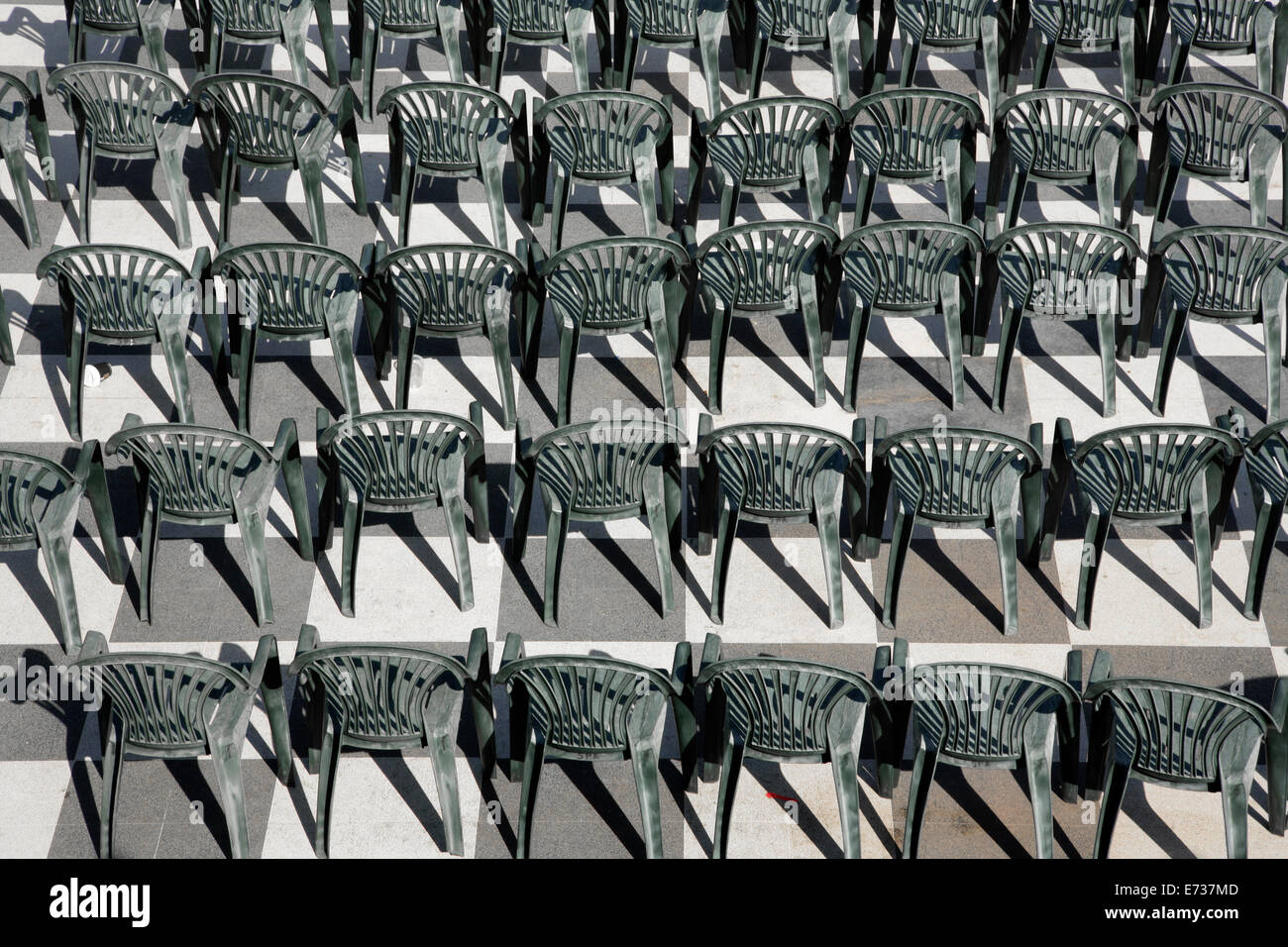 Rows of empty green plastic chairs Stock Photo - Alamy
